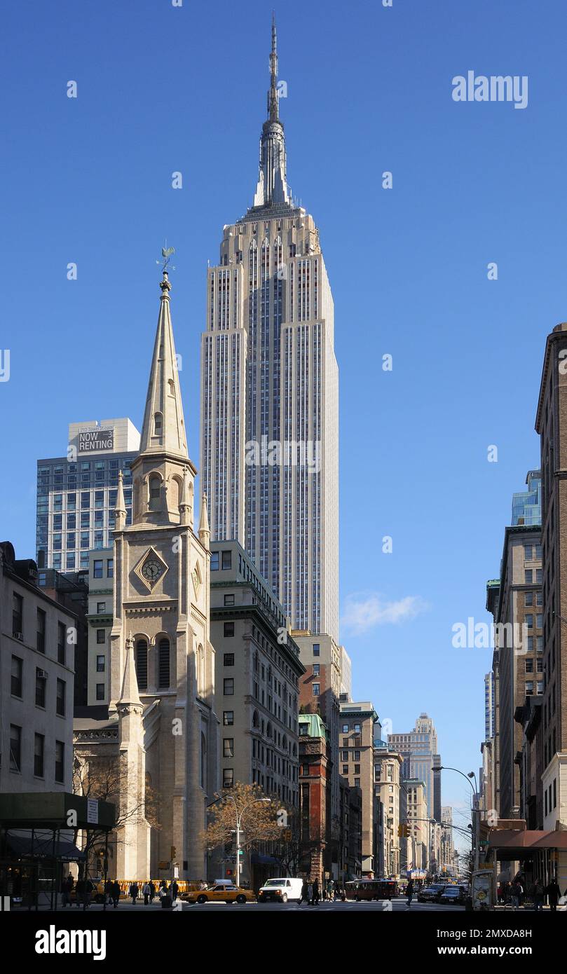 View of the Empire State Building towering above 5th Avenue, an iconic symbol of New York's ...
