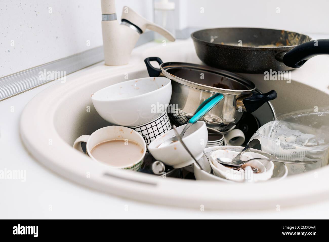 Dirty dishes and frying pan in kitchen after lunch in the kitchen sink ...