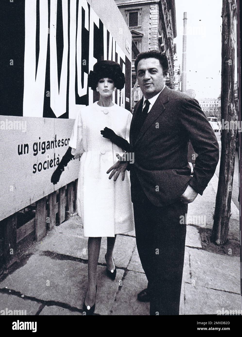 Federico Fellini (1920-1993) and a model wearing a Simonetta coat ...