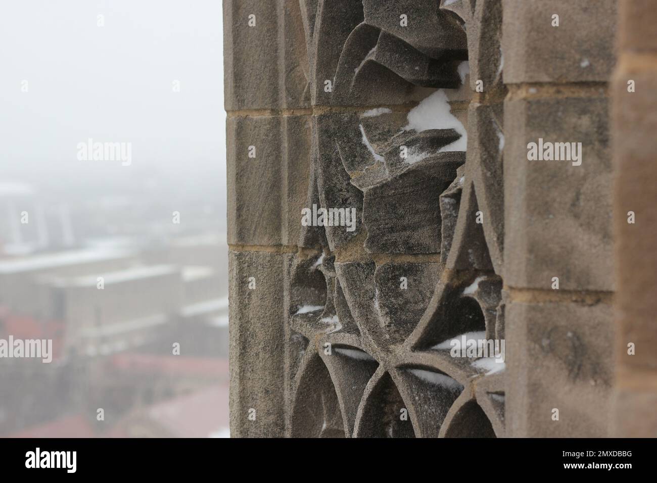 A detail of a medieval stone tower weathering the cold winter storm ...
