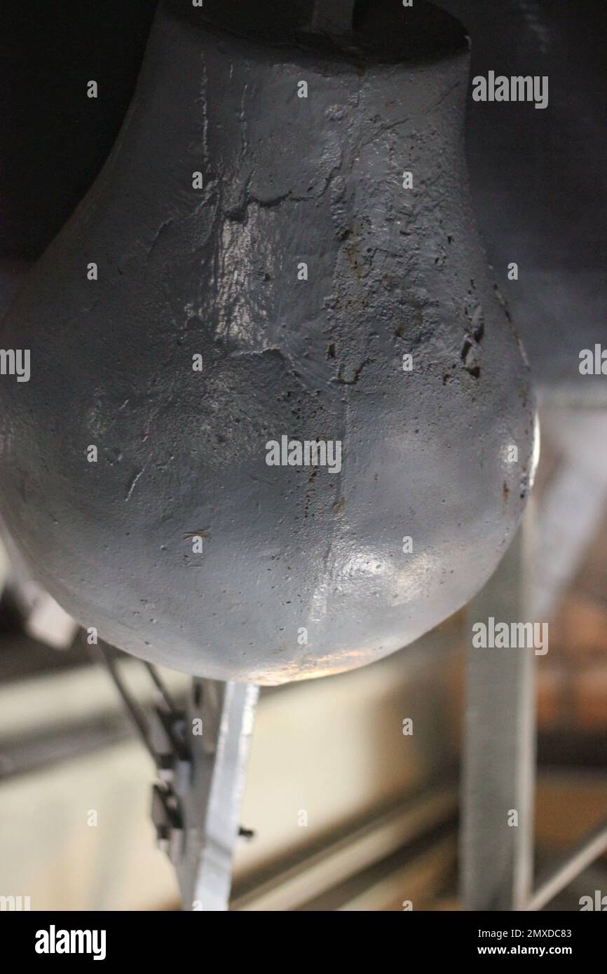 The clapper of a huge forged iron bell Stock Photo - Alamy