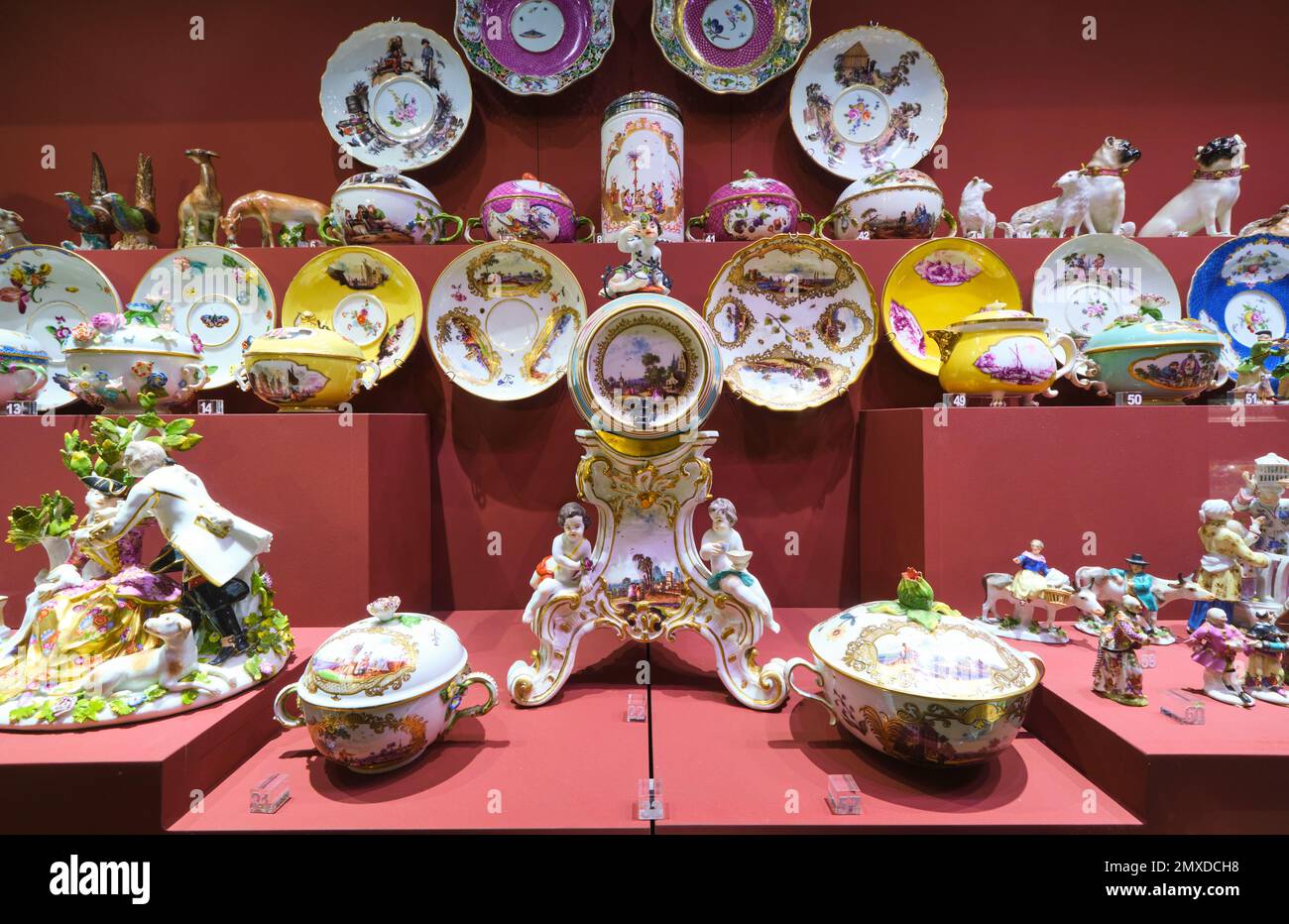 A display case with old porcelain, china, dishes, bowls, figurines. At ...
