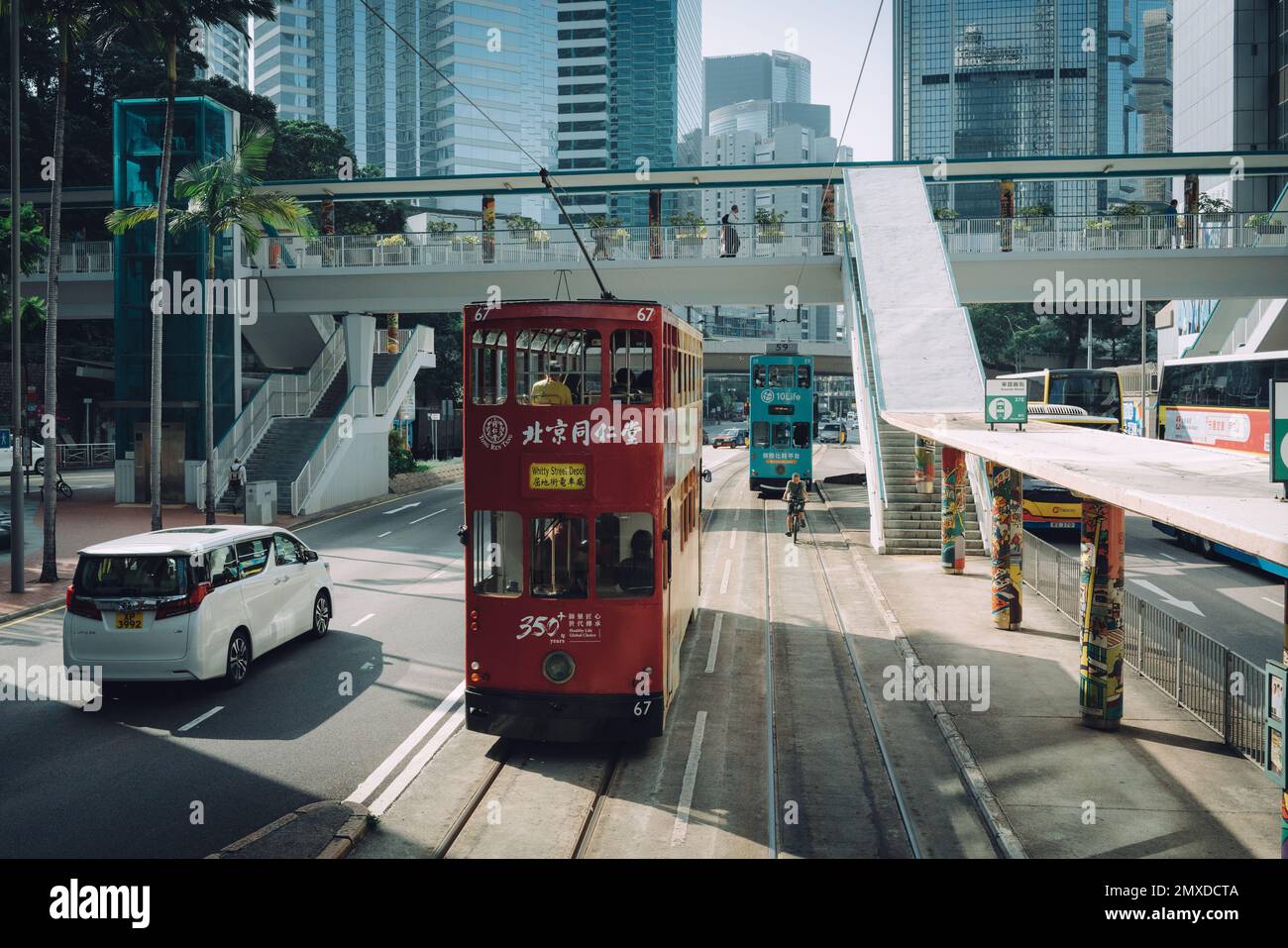 A red classic tram in the street of Hong Kong in the afternoon sunlight ...
