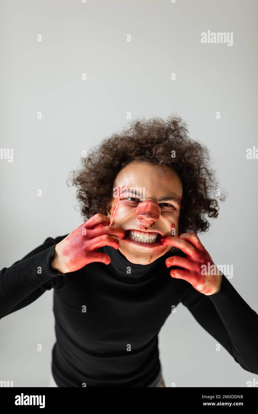 wounded and angry african american man with bleeding face and broken ...