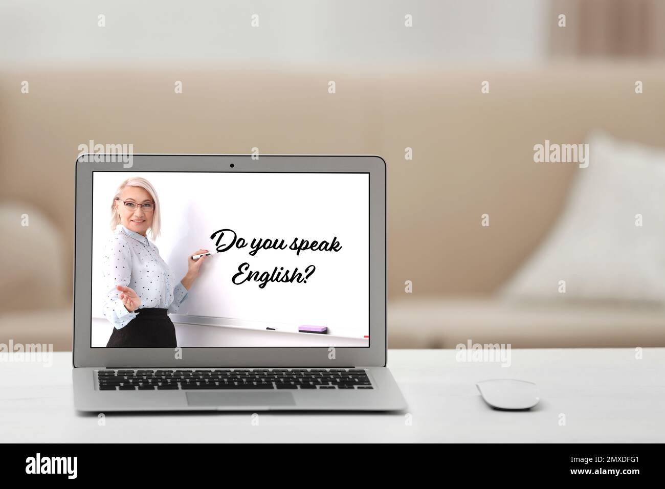 Modern laptop for online English learning with teacher on table indoors ...