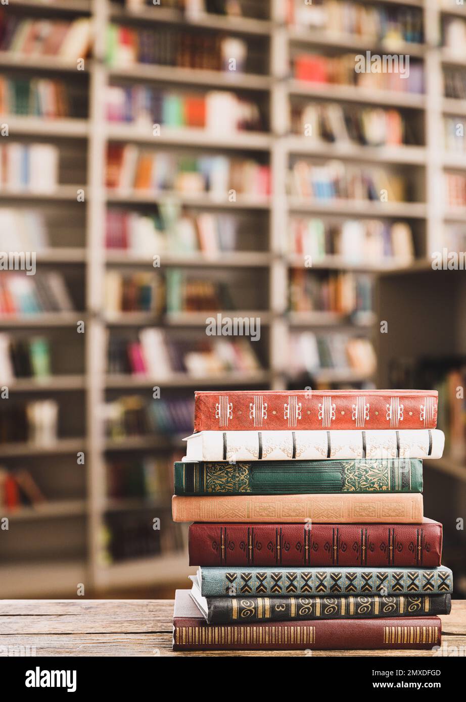 Stack of old vintage books on table in library Stock Photo - Alamy