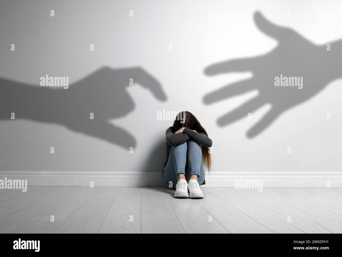 Scared teenage girl suffering from sciophobia and phantoms behind her ...