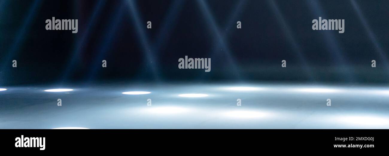 blurred rays of light on the disco floor. white blue neon searchlight ...