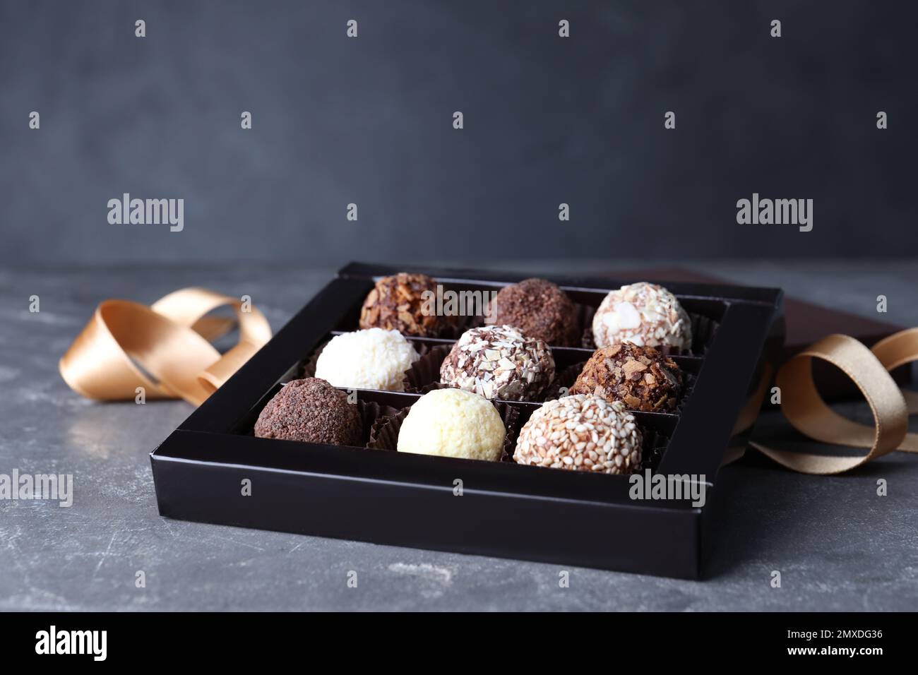 Delicious chocolate candies in box on light grey table Stock Photo - Alamy