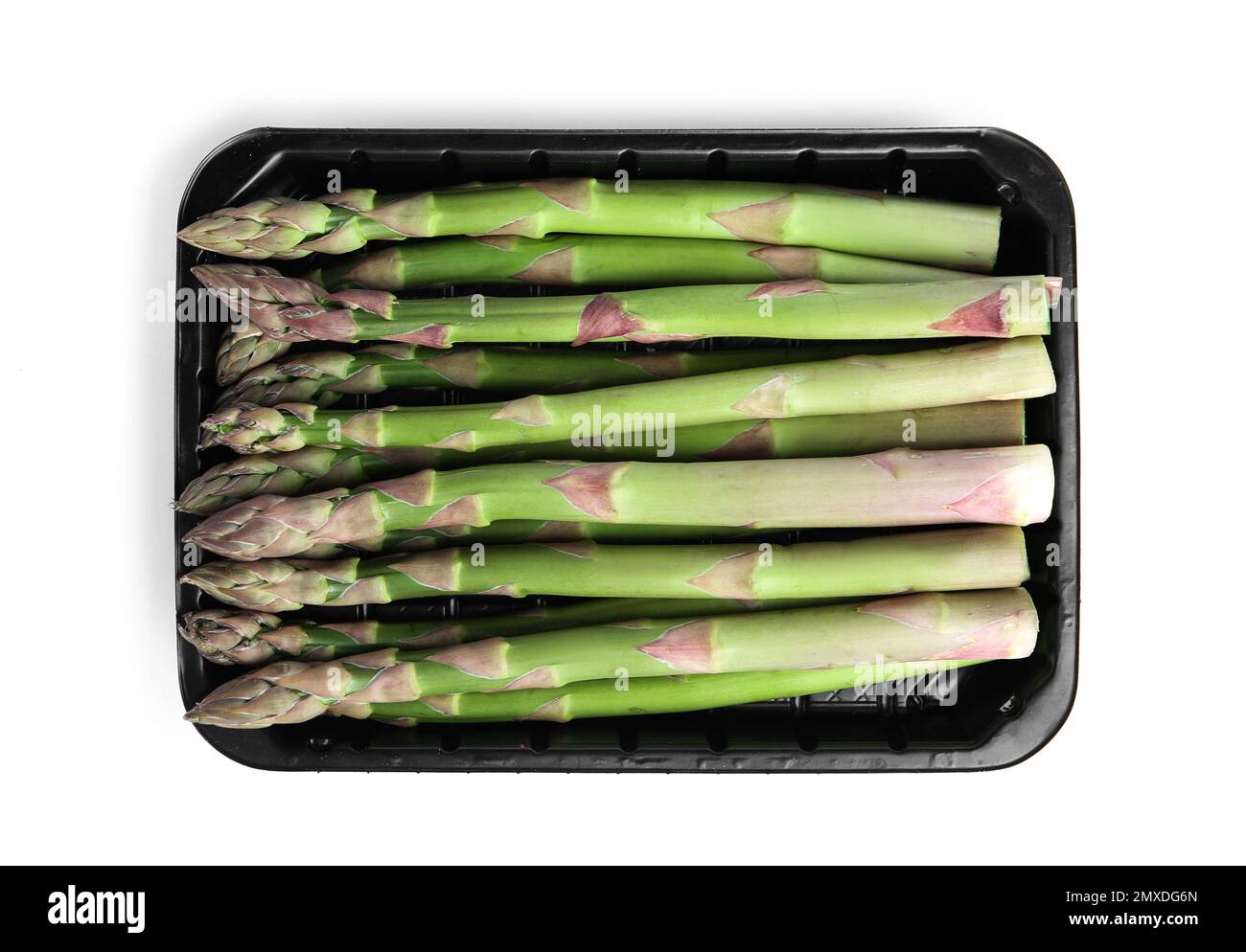 Fresh raw asparagus in plastic container isolated on white, top view ...