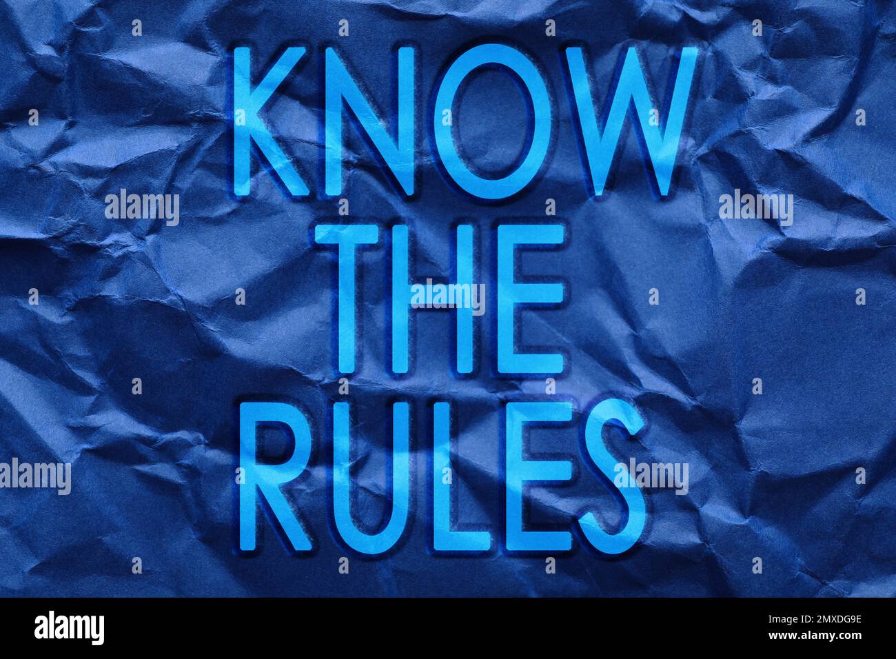 Phrase Know the rules on blue crumpled paper Stock Photo - Alamy