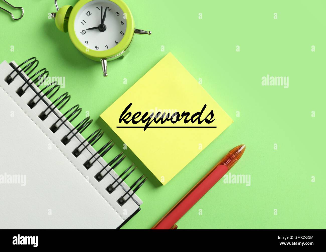 Modern office accessorises and note with text KEYWORDS on green ...