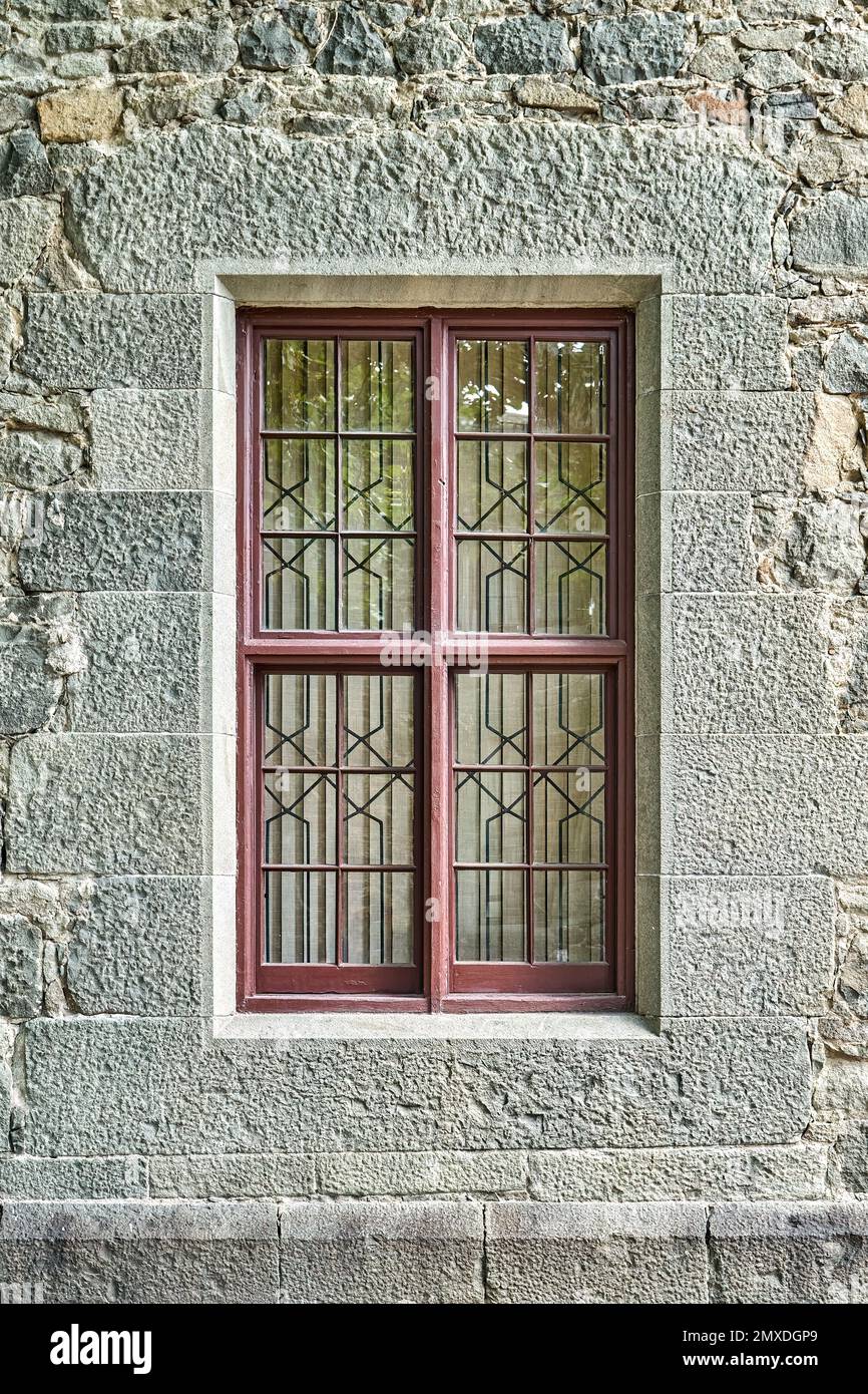 Old windows with wrought iron grating on stone wall of historical ...