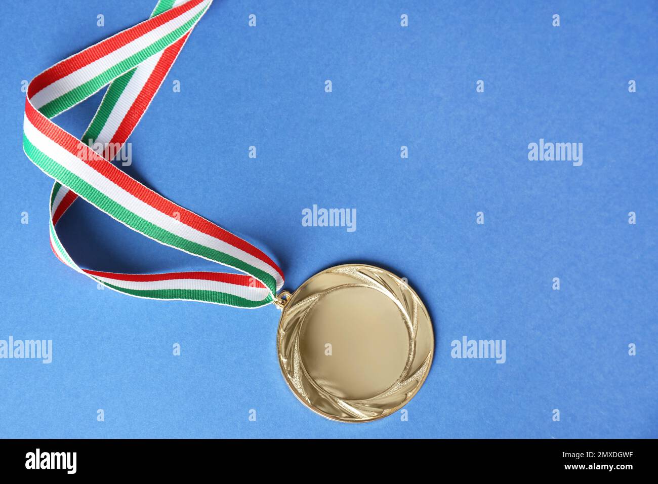 Gold medal on blue background, top view. Space for design Stock Photo ...