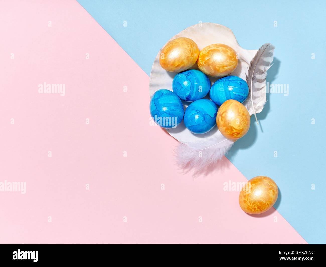 Creative layout with colored easter eggs arranged in a seashell on ...