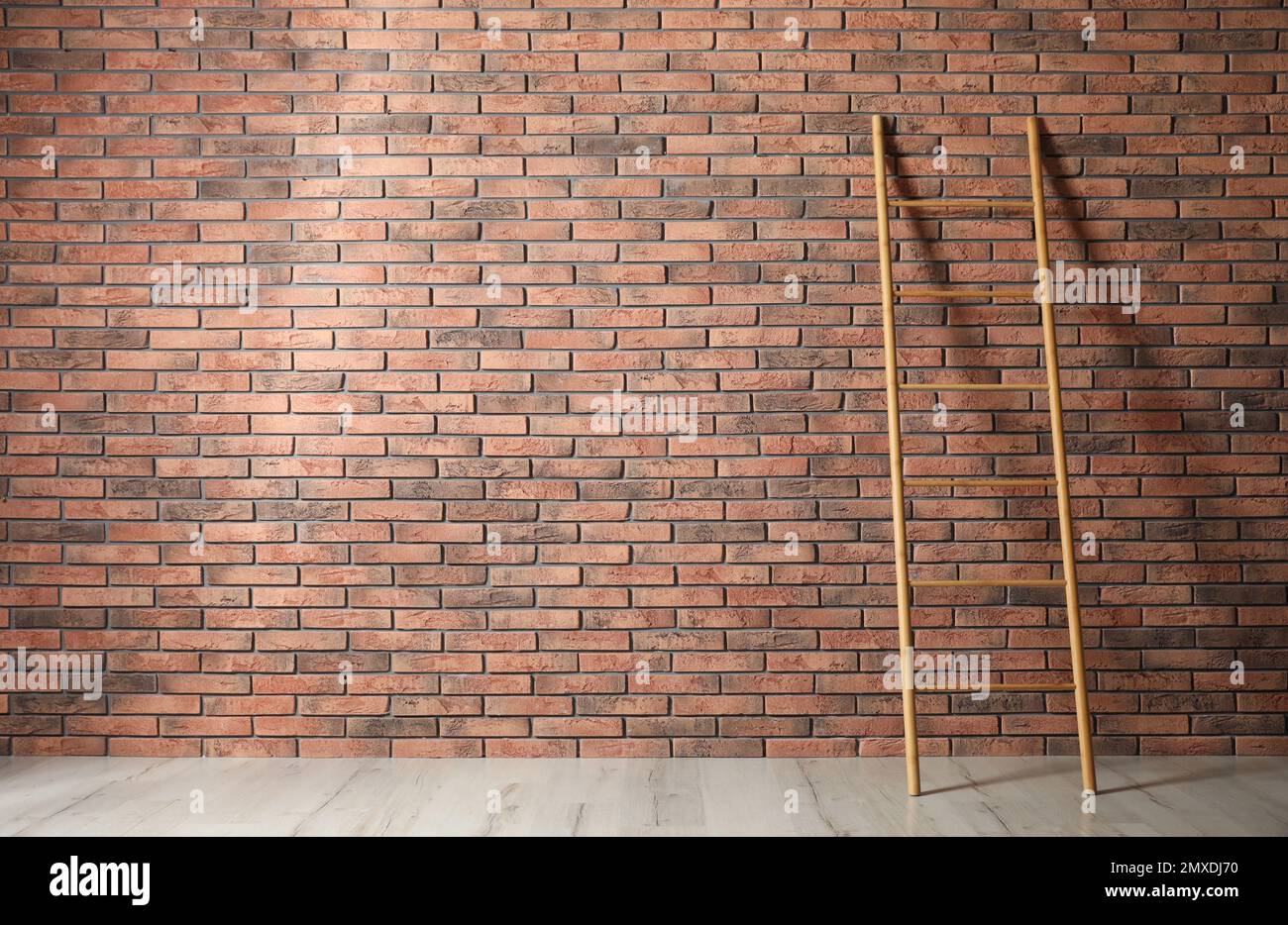 Modern wooden ladder near brick wall. Space for text Stock Photo - Alamy