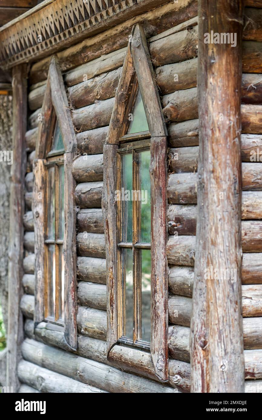 Old log cabin with lancet windows in a public park close-up view Stock ...