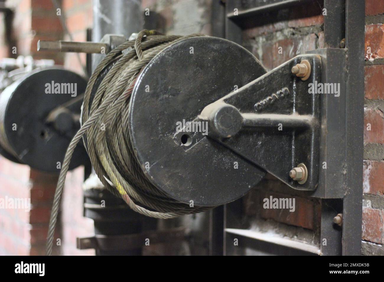 Strong cable would around an old handcranked pulley Stock Photo - Alamy