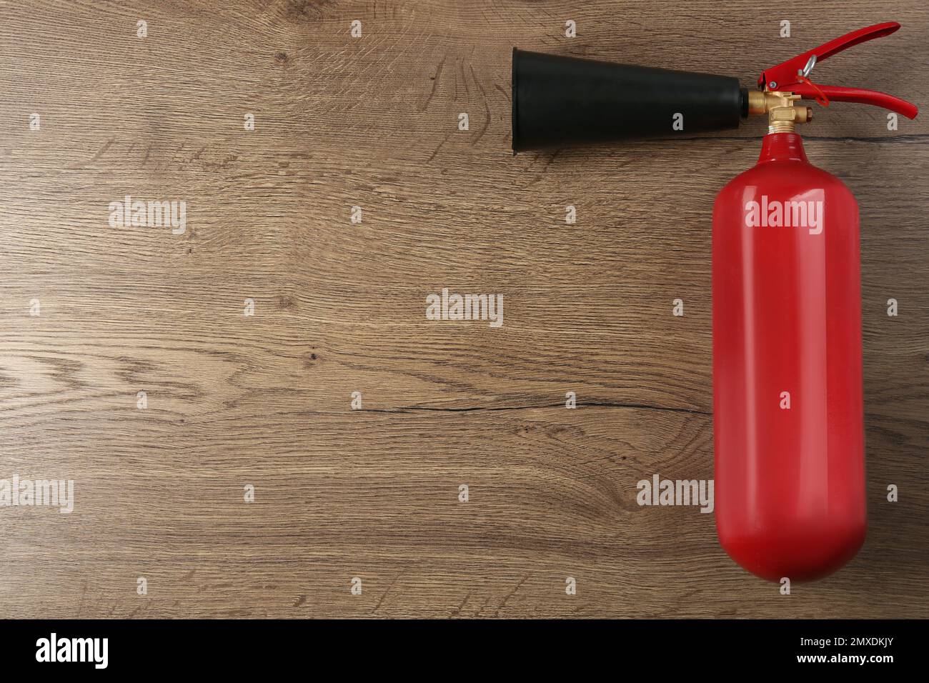 Fire extinguisher on wooden background, top view. Space for text Stock ...