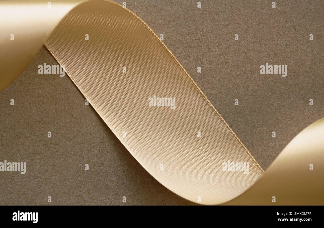 close up macro antique satin golden silk fabric ribbon texture abstract ...