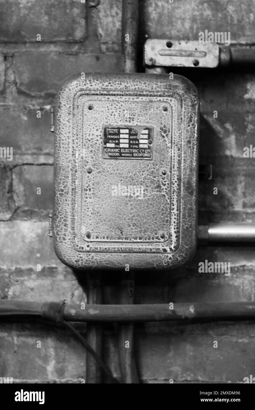 Vintage metal mechanical and electrical panel box in a black and white ...