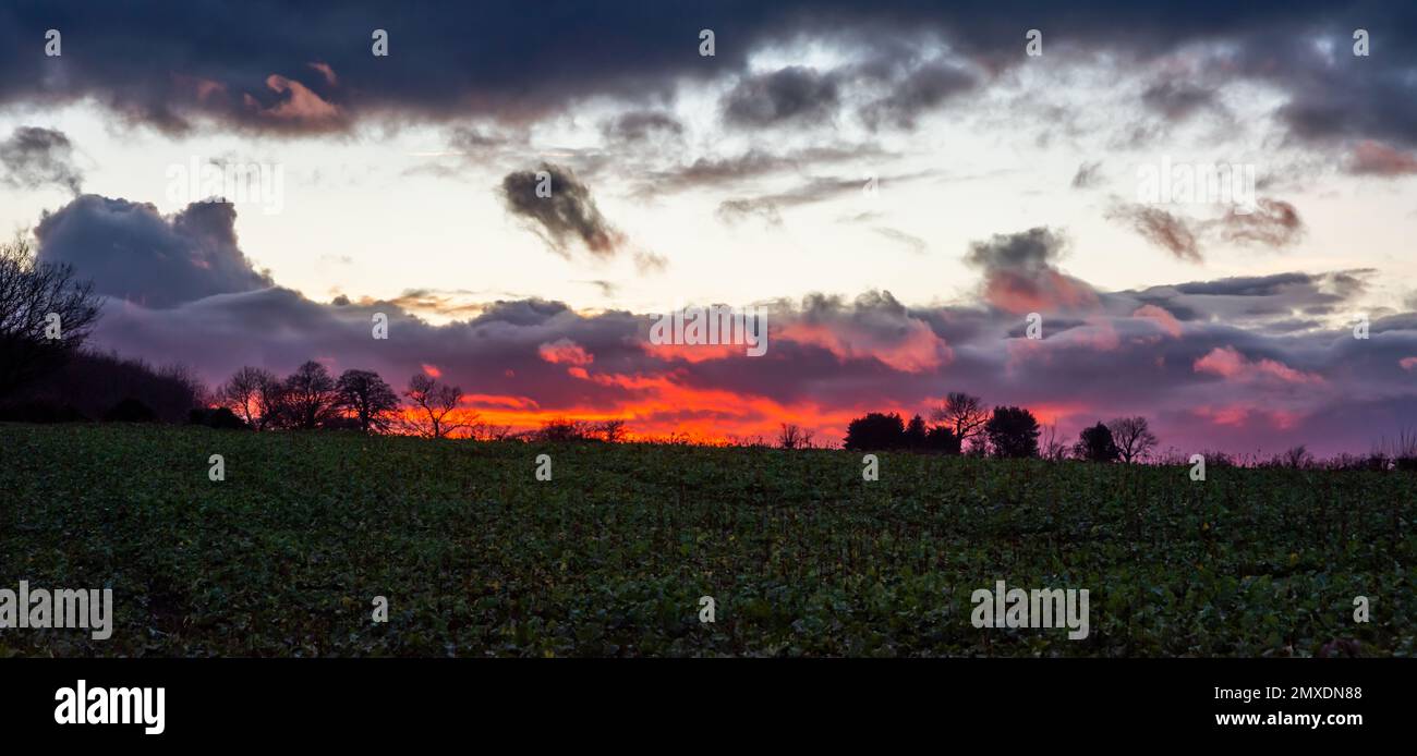 Fiery Clouds as the sun set Stock Photo - Alamy