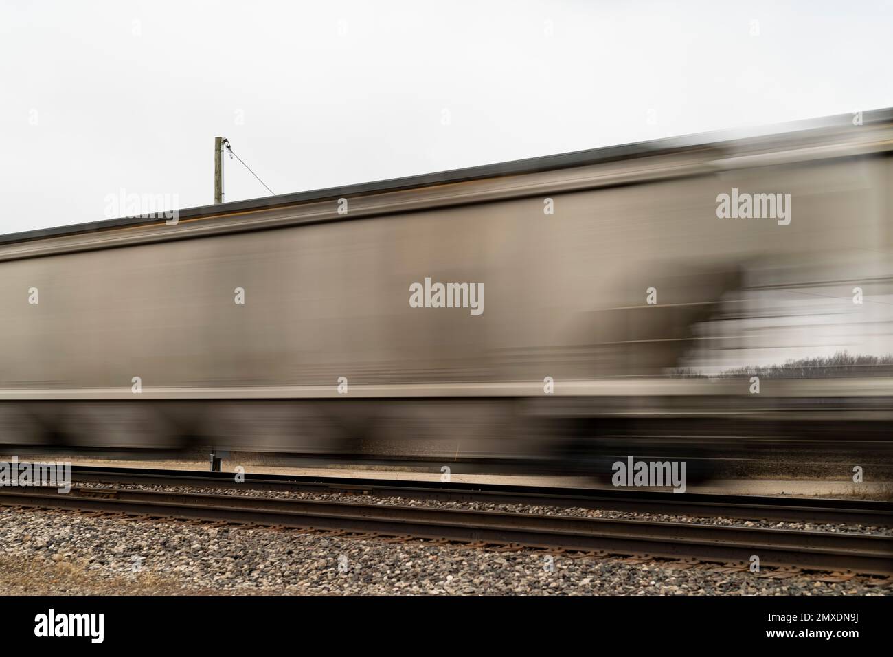 An industrial train moving fast in motion on the rails Stock Photo - Alamy
