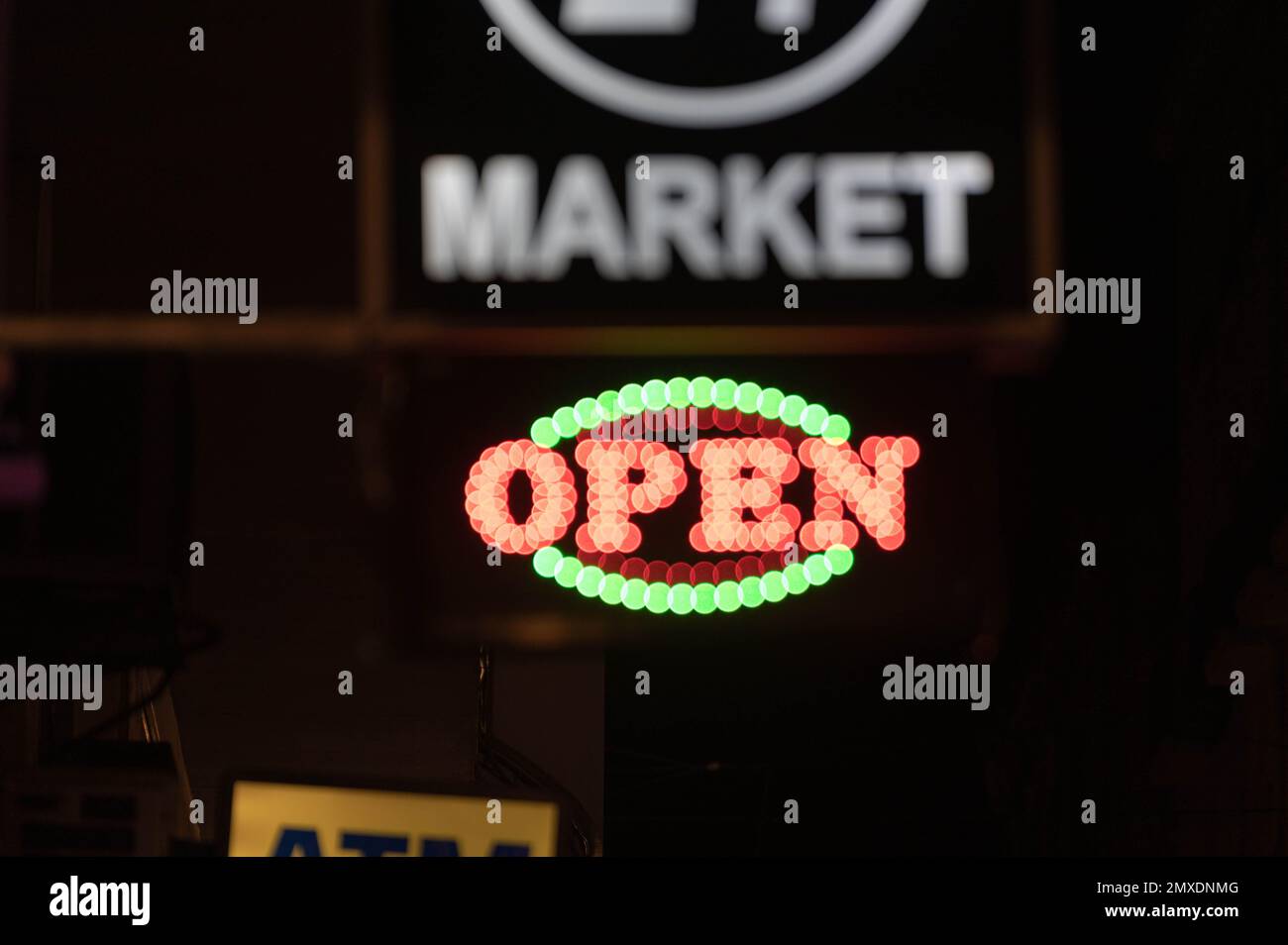 a neon led sign open sign on a door of a store Stock Photo - Alamy