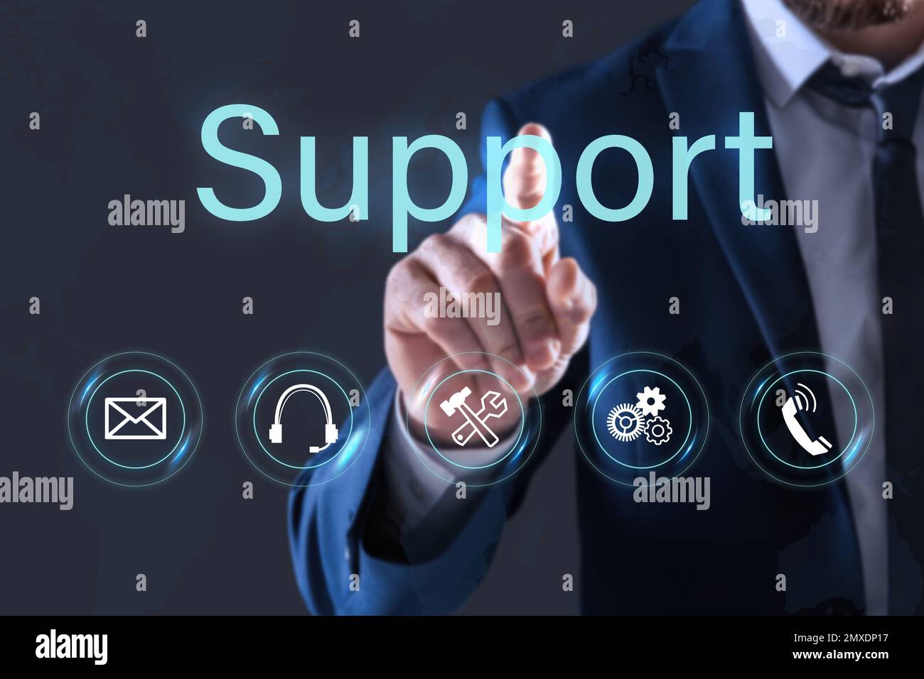 Man pointing at icon on virtual screen against dark background, closeup ...