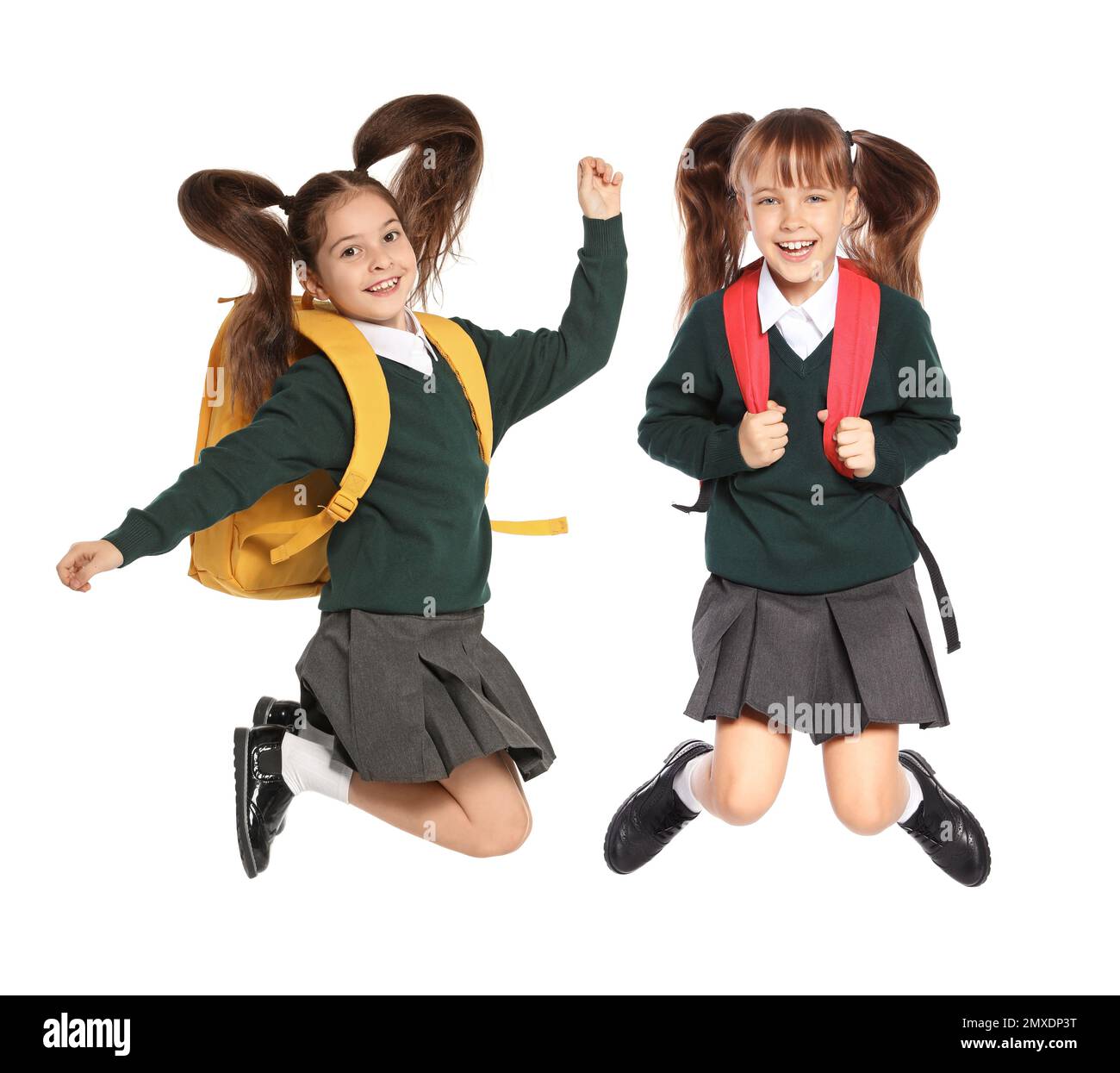 Children in school uniform jumping on white background Stock Photo - Alamy