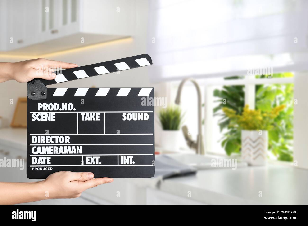 Assistant holding clapperboard on filming location, closeup. Cinema ...