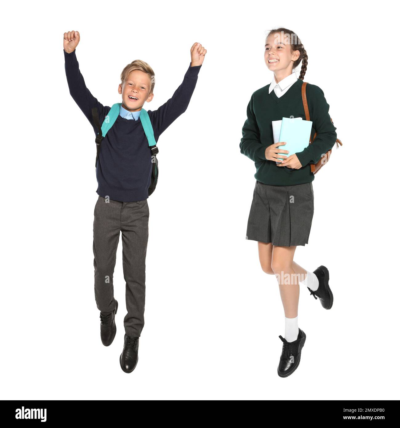 Children in school uniform jumping on white background Stock Photo - Alamy
