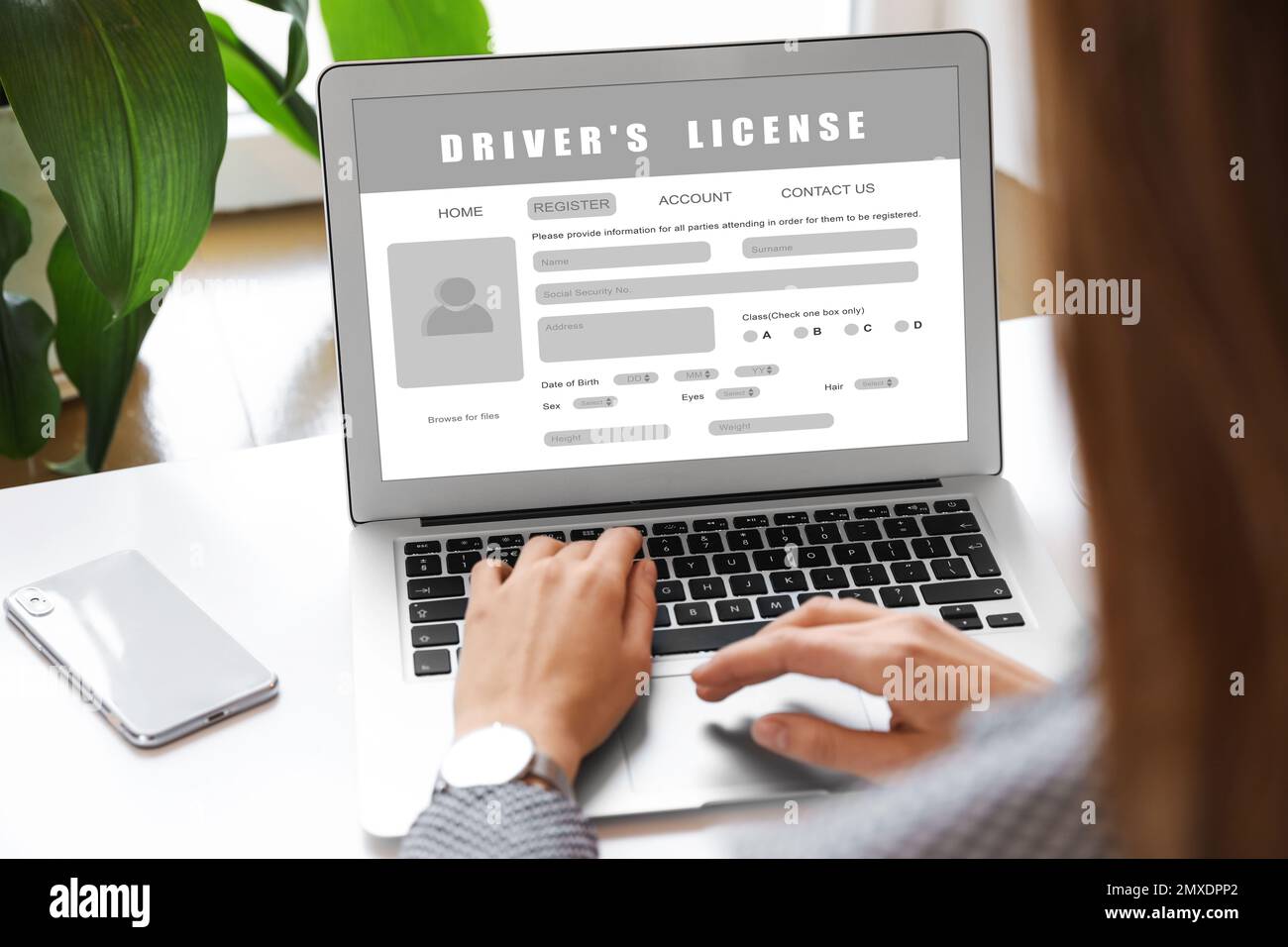 Woman filling in driver's license form online on website using laptop, closeup Stock Photo - Alamy