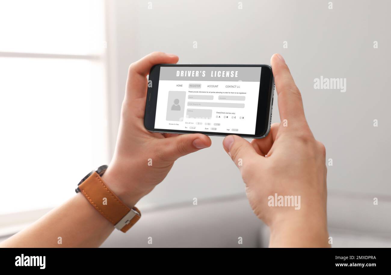 Man filling in driver's license form online on website using smartphone, closeup Stock Photo - Alamy