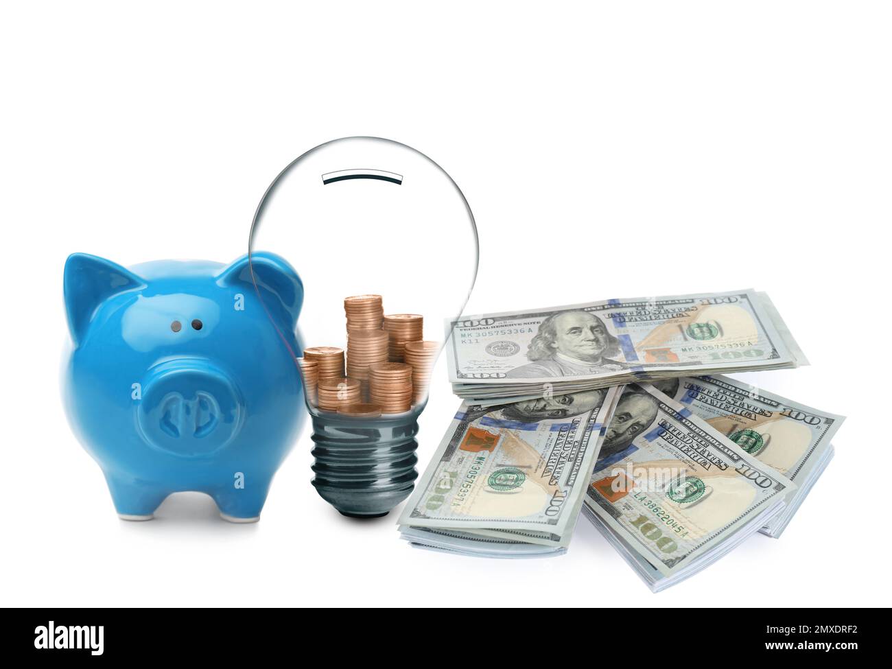 Light bulb with stacked coins inside, piggy bank and banknotes on white ...