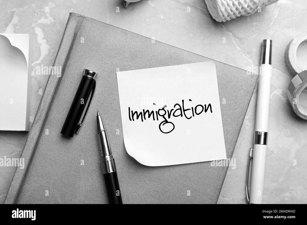 Note with word IMMIGRATION and stationery on grey table, flat lay Stock ...
