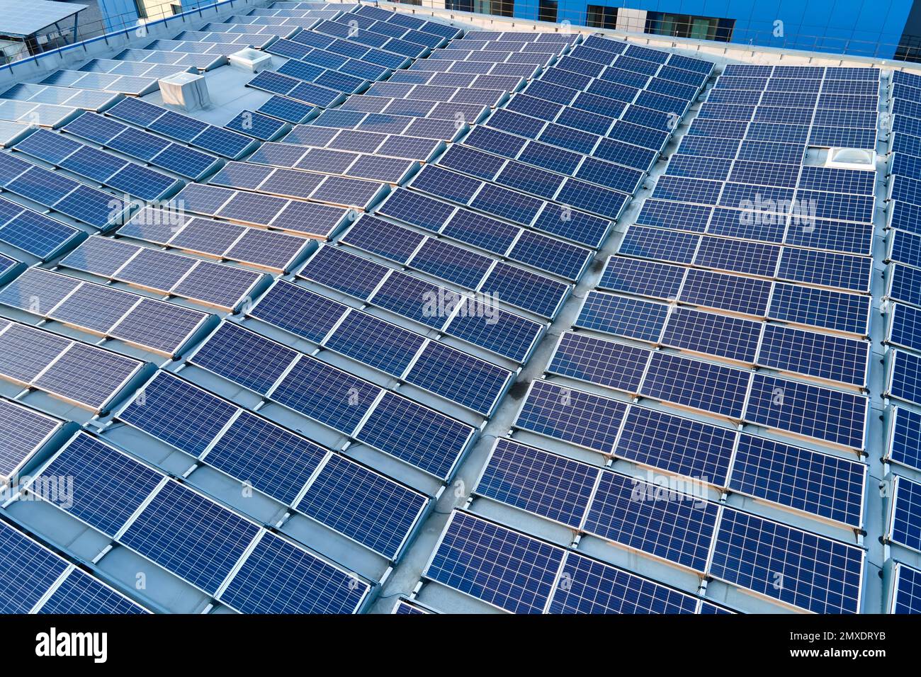 Aerial view of blue photovoltaic solar panels mounted on industrial ...