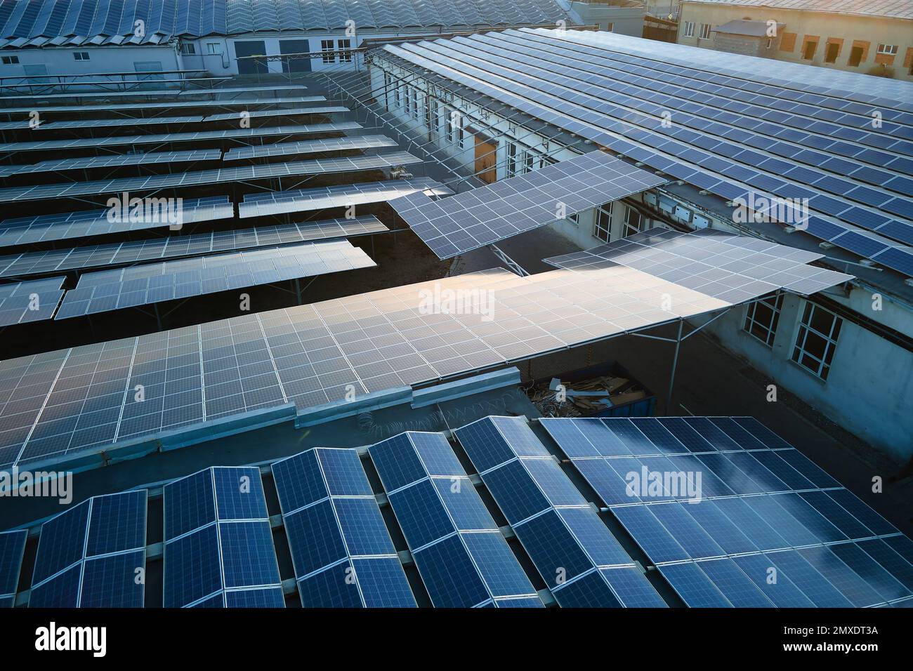 Aerial view of blue photovoltaic solar panels mounted on industrial ...