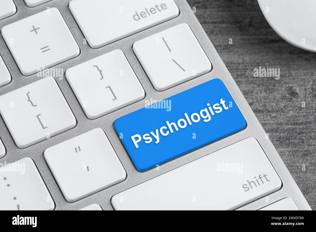 Modern computer keyboard with word PSYCHOLOGIST on table, above view ...