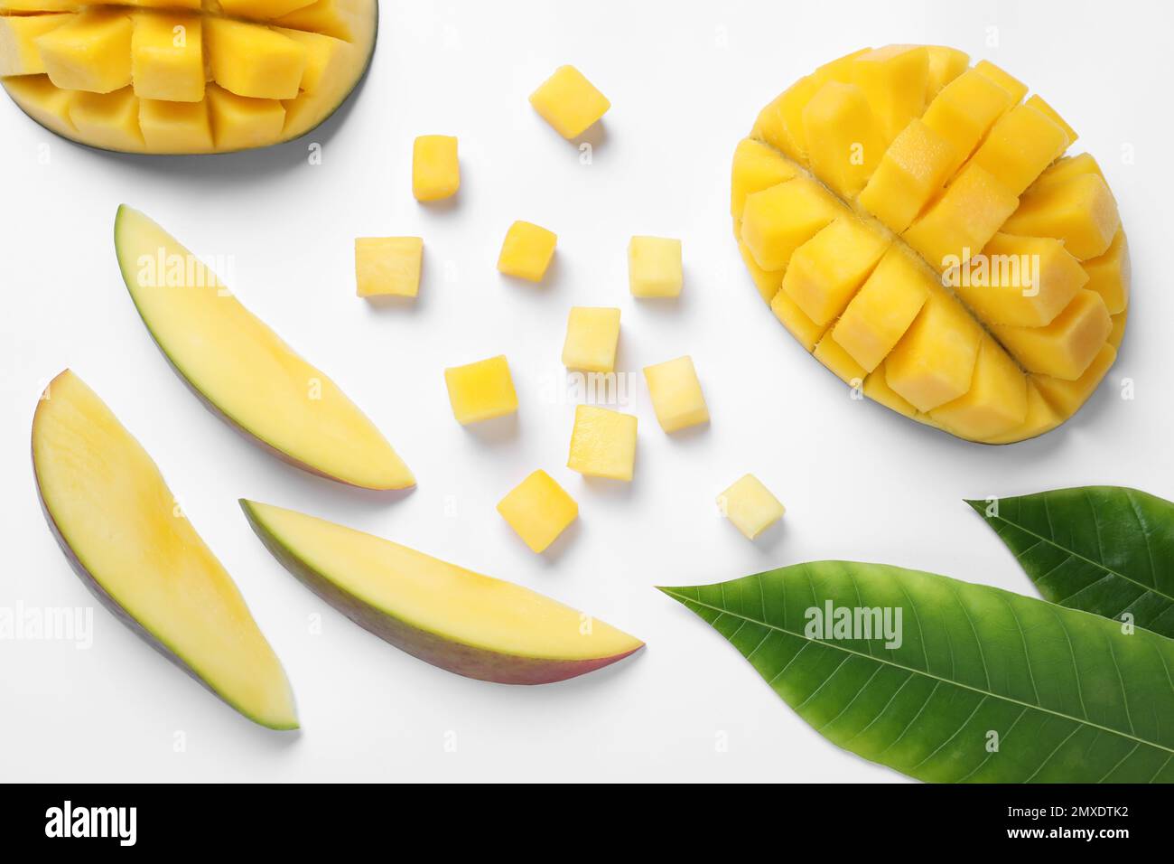Cut fresh ripe mango fruits on white background, top view Stock Photo ...
