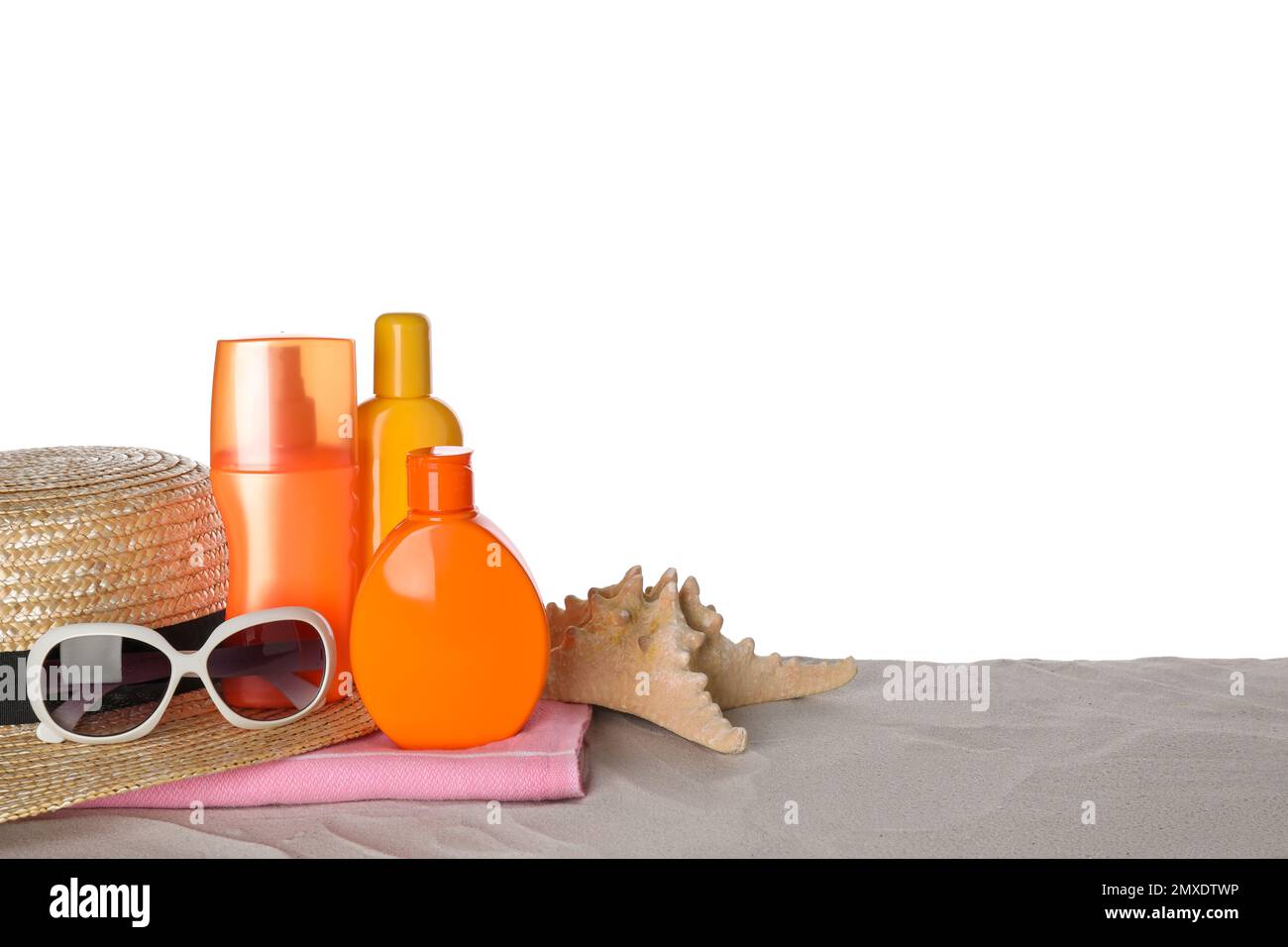 Composition with sun protection products on sand against white ...