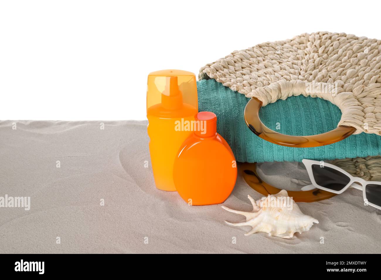 Composition with sun protection products on sand against white ...