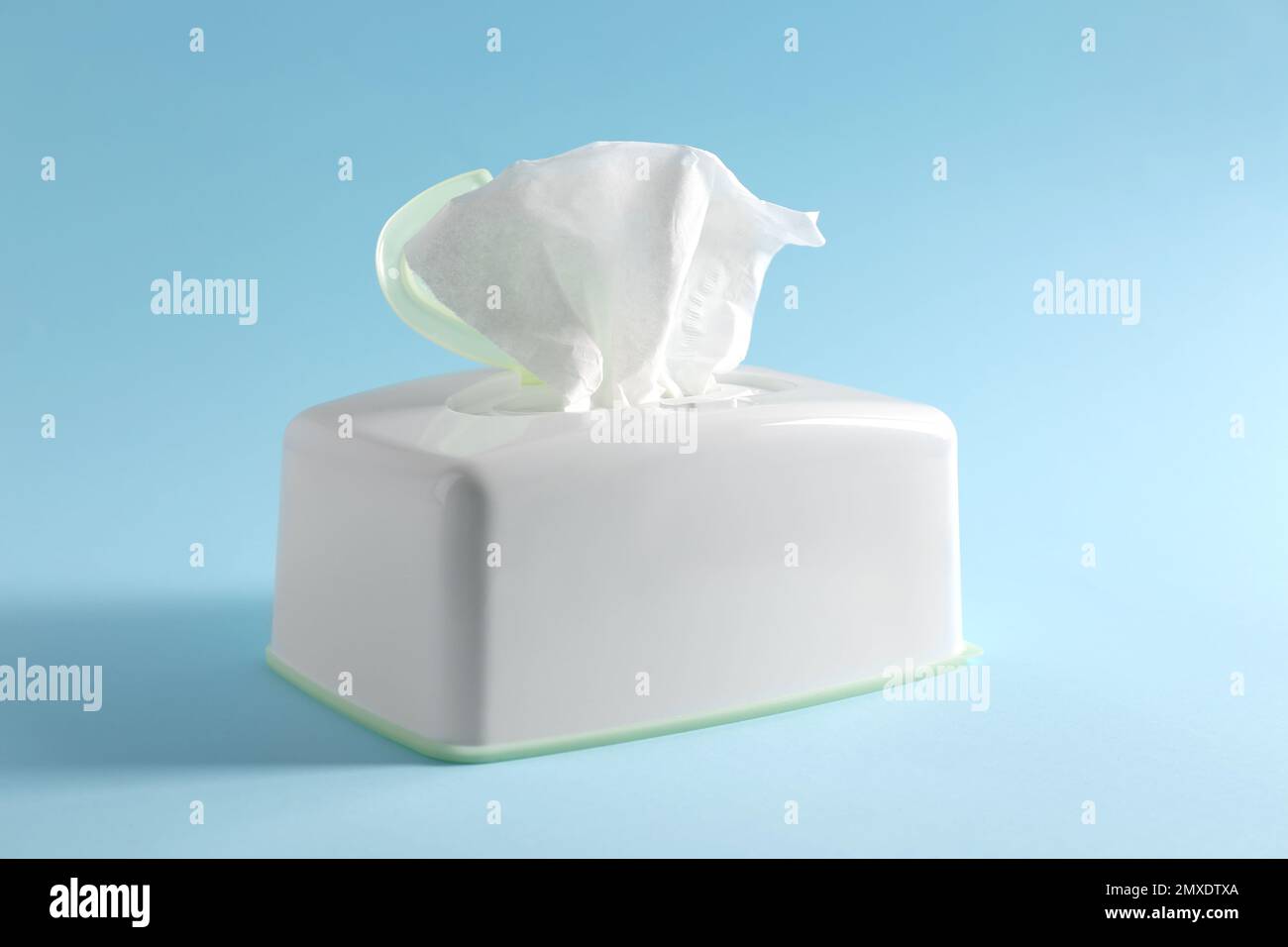 Box of paper tissues on light blue background Stock Photo - Alamy