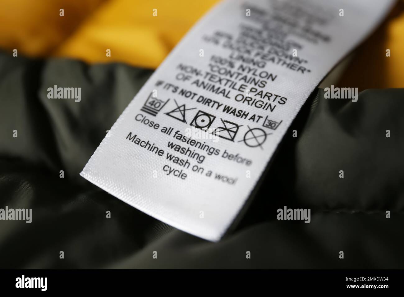 Clothing label with care symbols on color jacket, closeup view Stock ...