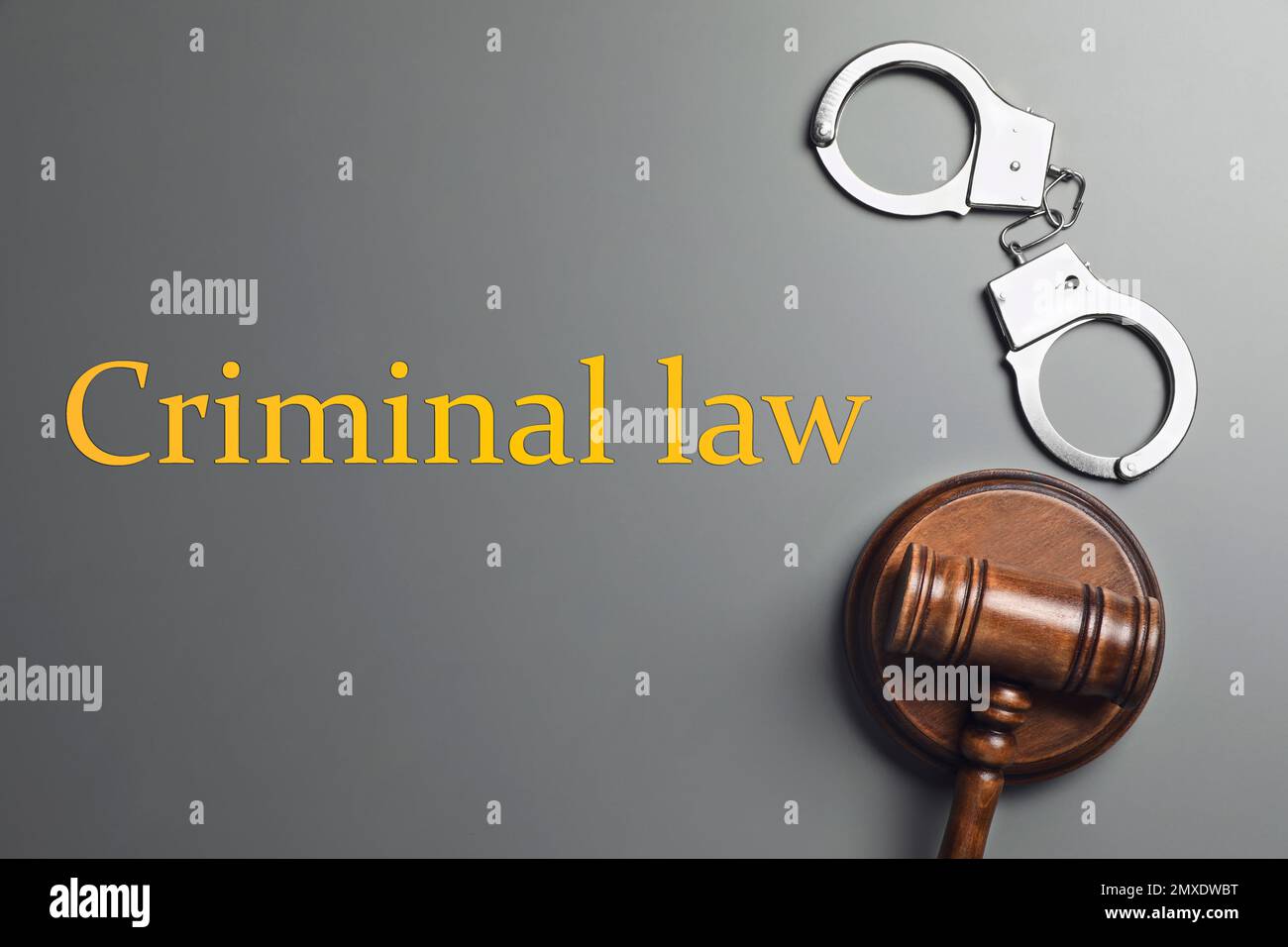 Judge's gavel and handcuffs on grey background, flat lay. Criminal law ...