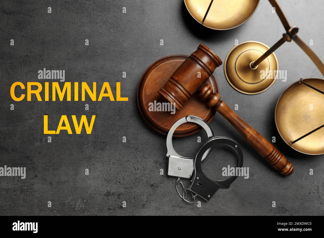 Judge's gavel, handcuffs and scales on grey background, flat lay ...