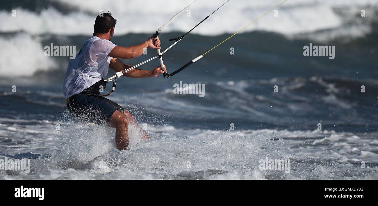 Athletic man jump on kite surf board on a sea waves Stock Photo - Alamy