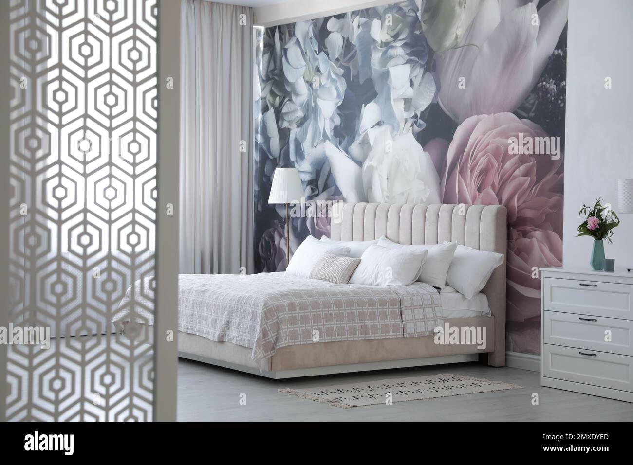 Big comfortable bed in modern room. Interior design Stock Photo - Alamy