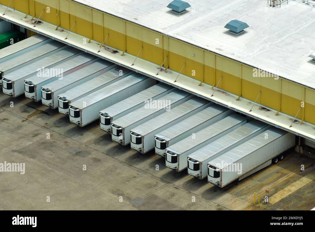 Aerial view of large commercial distribution center with many trucks ...
