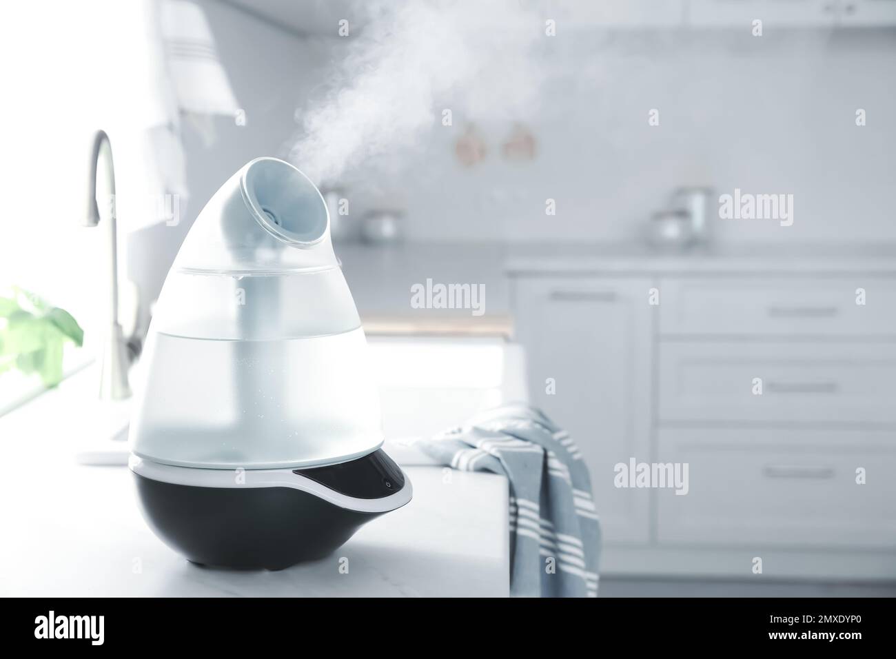 Modern air humidifier on counter in kitchen. Space for text Stock Photo ...